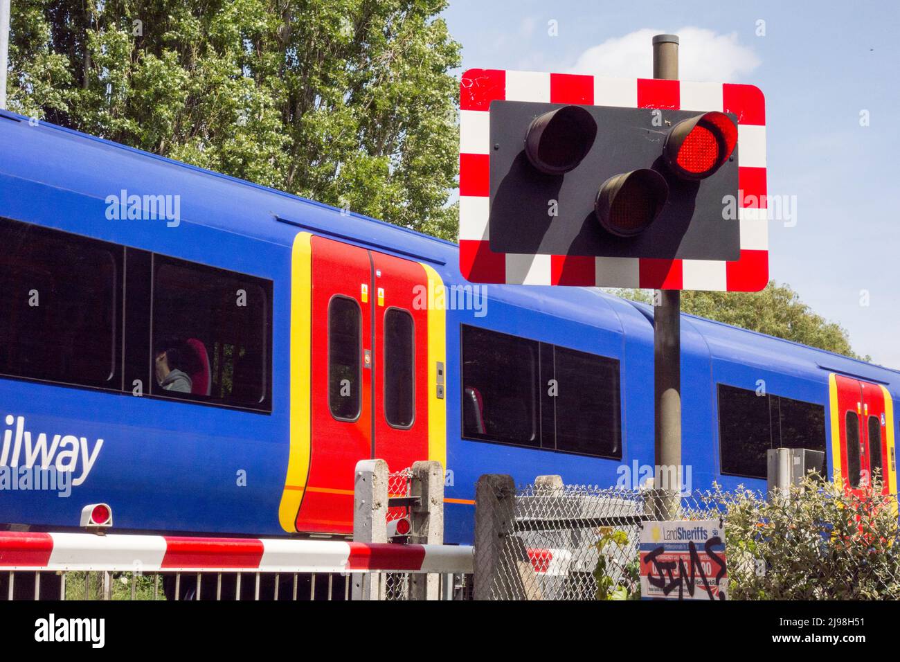 A South Western Railway train passing Vine Road level crossing, Barnes ... A South Western Railway train passing Vine Road level crossing, Barnes ...