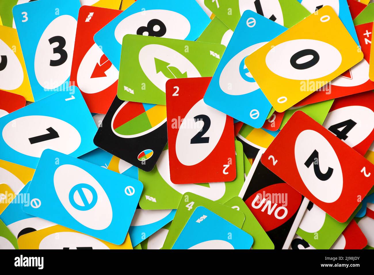 TERNOPIL, UKRAINE - MAY 15, 2022: Many colorful UNO game cards. UNO is ...