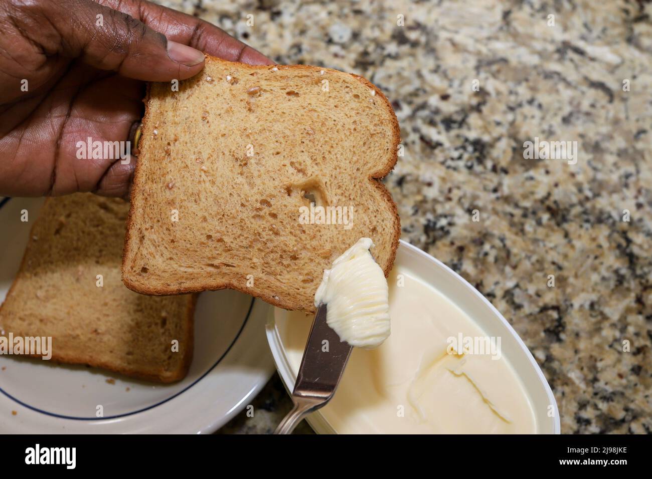 Man buttering bread hi-res stock photography and images - Alamy
