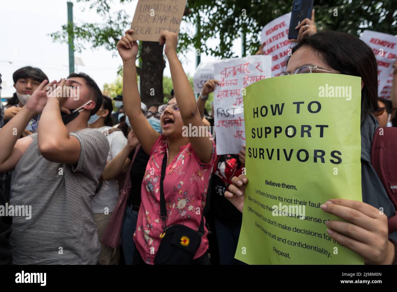 Youths hold placards while chanting slogans during the protest ...