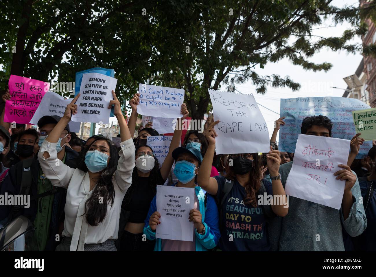 Youths hold placards while chanting slogans during the protest ...