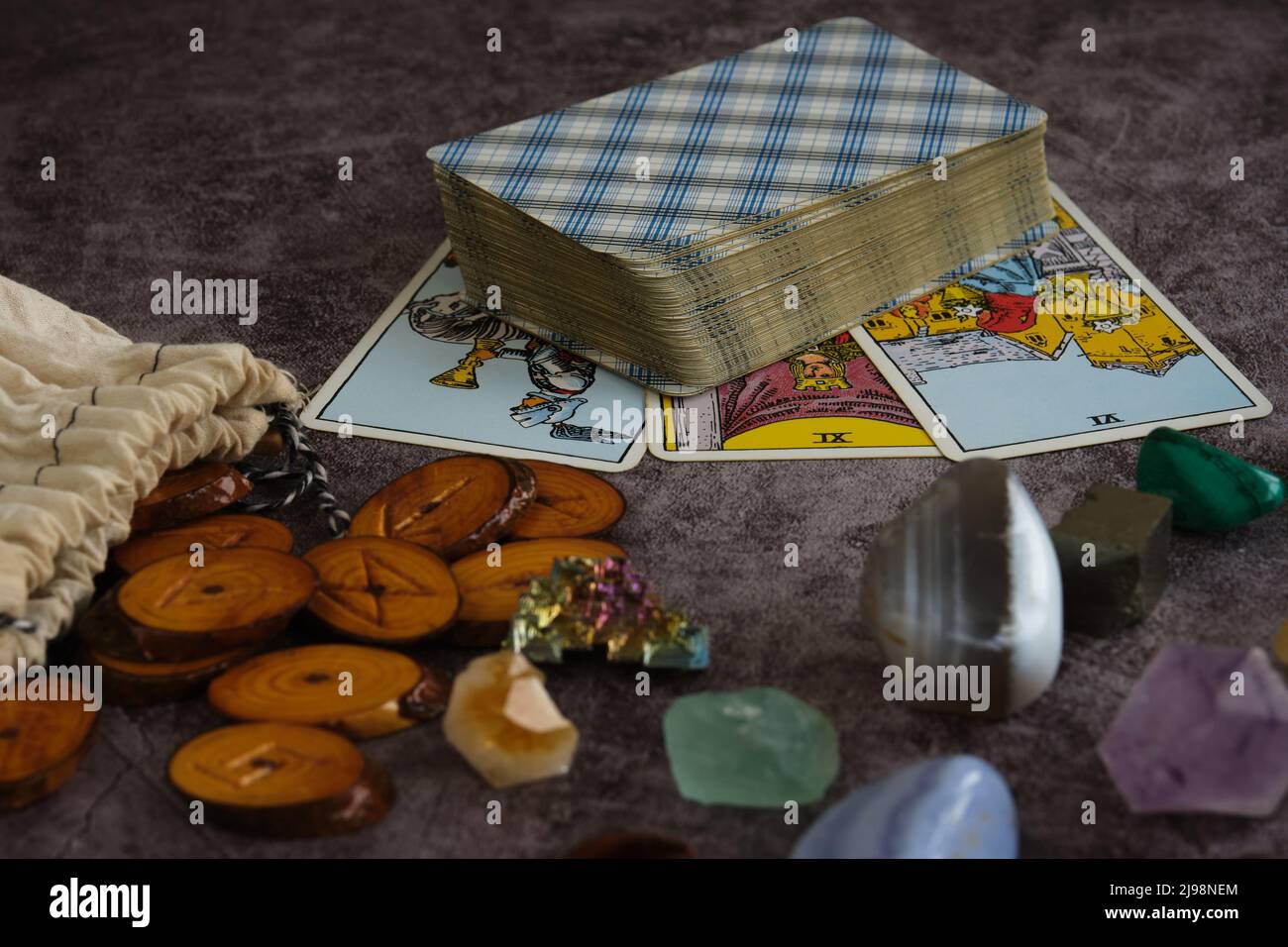 wooden runes and tarot cards on the table Stock Photo - Alamy