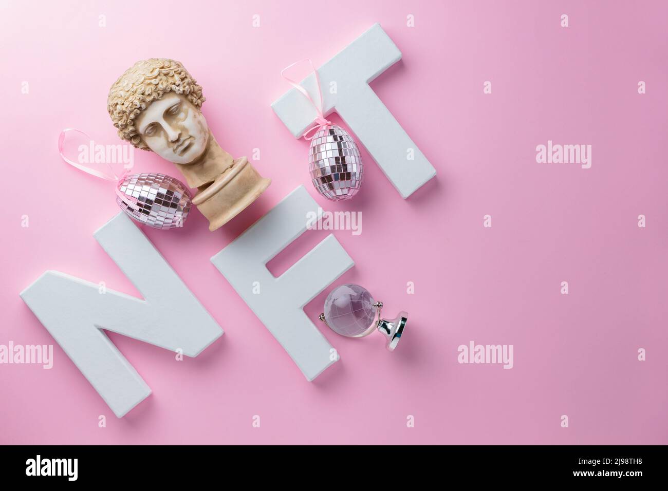 NFT (Non-Fungible token) and antique statue on a pink background ...