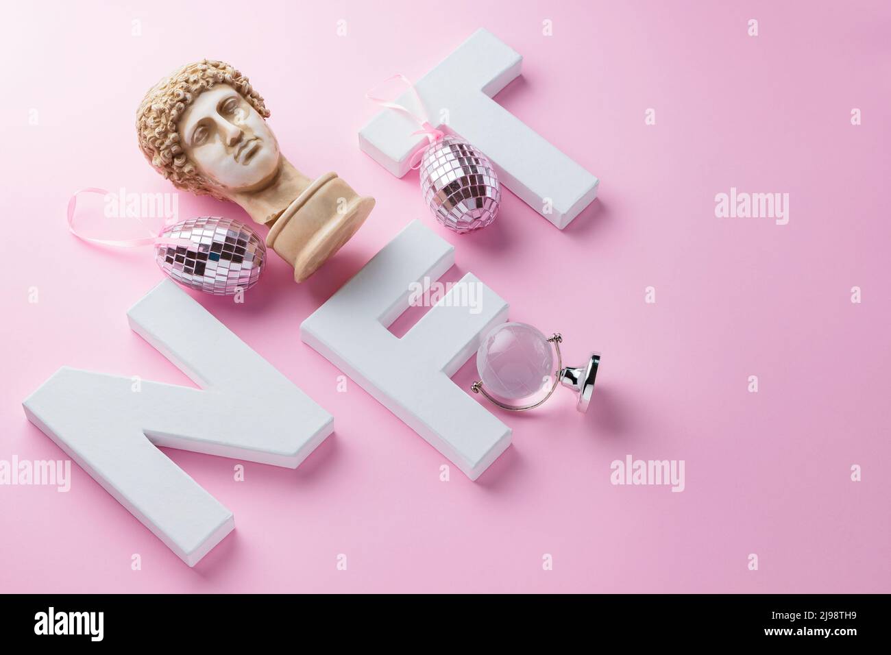 NFT (Non-Fungible token) and antique statue on a pink background ...