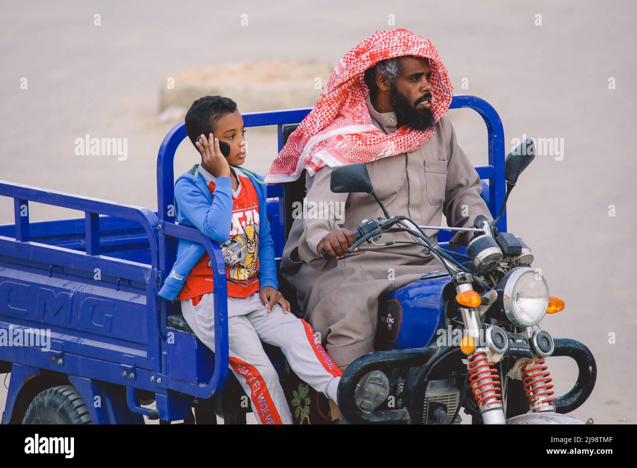 Egyptian man with children on street hi-res stock photography and ...
