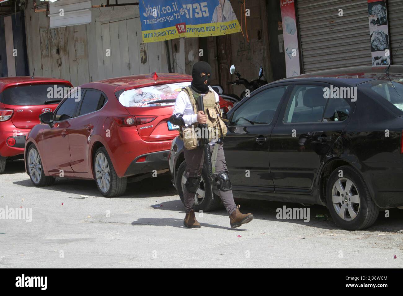 A gunman from the Islamic Jihad movement participates in the funeral of ...