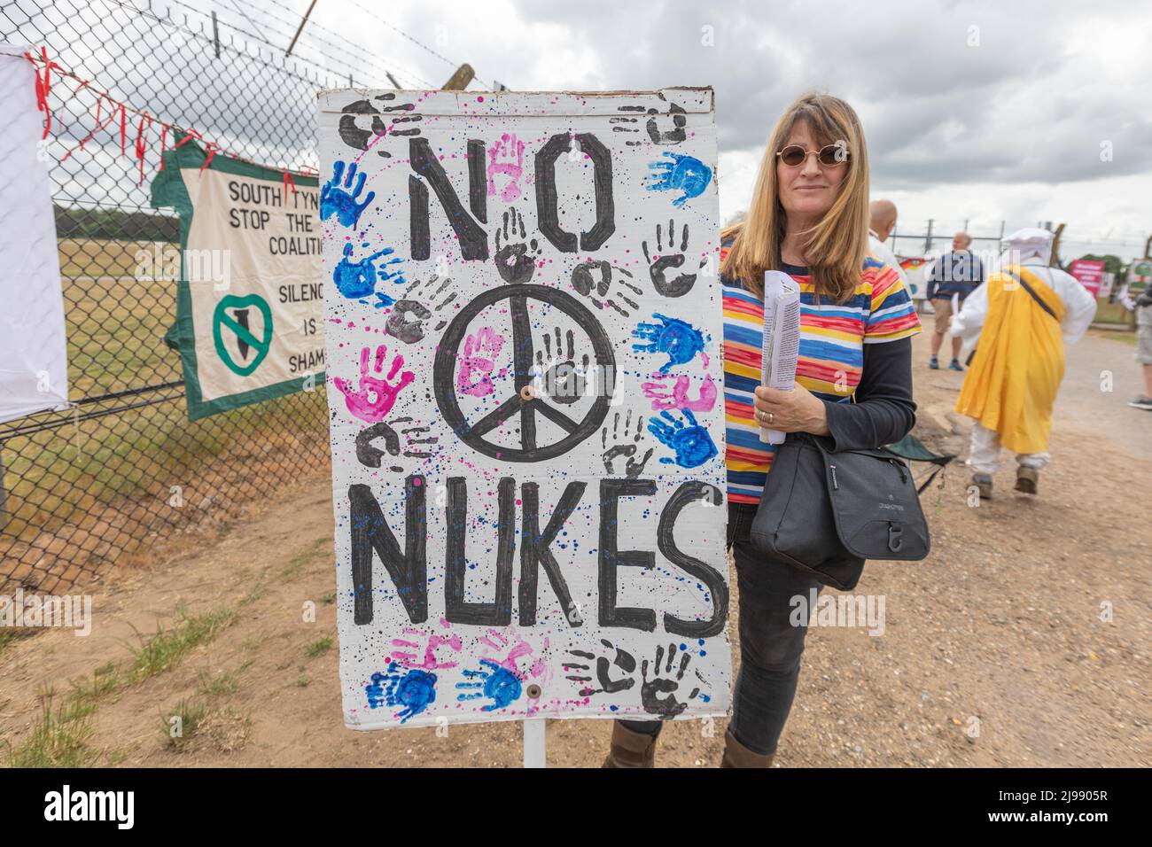 RAF Lakenheath, Suffolk, UK. 21st May, 2022. A protester with placard ...