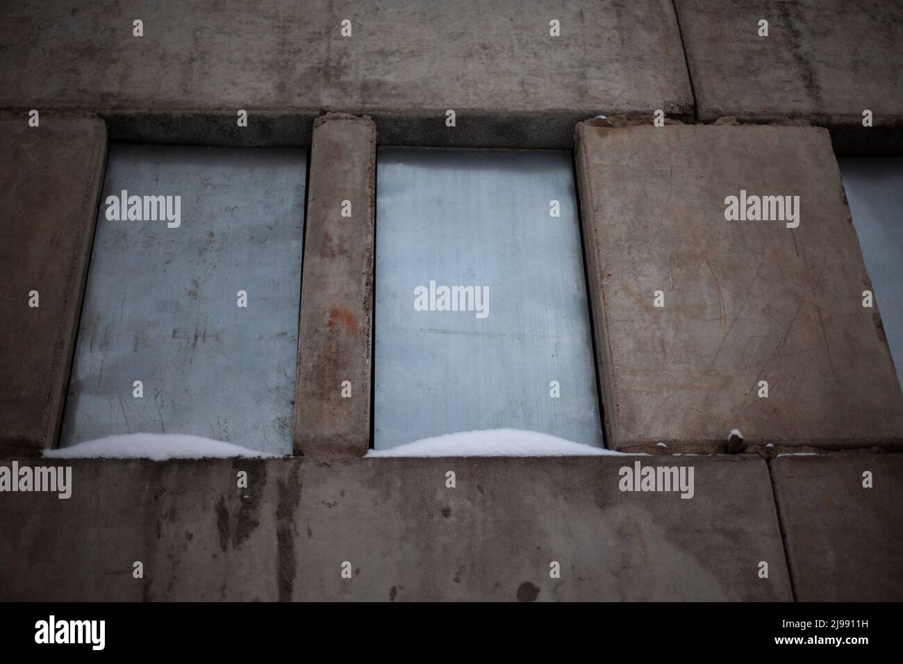 Abandoned building. Windows are tightly sealed with steel sheet. Locked ...