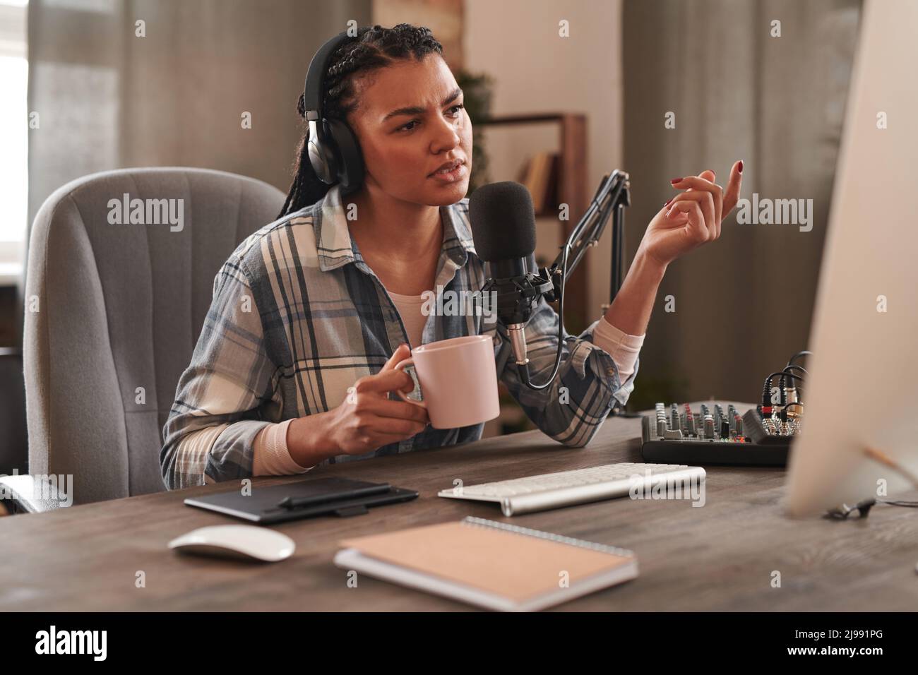 Horizontal medium portrait of modern female influencer sitting at ...