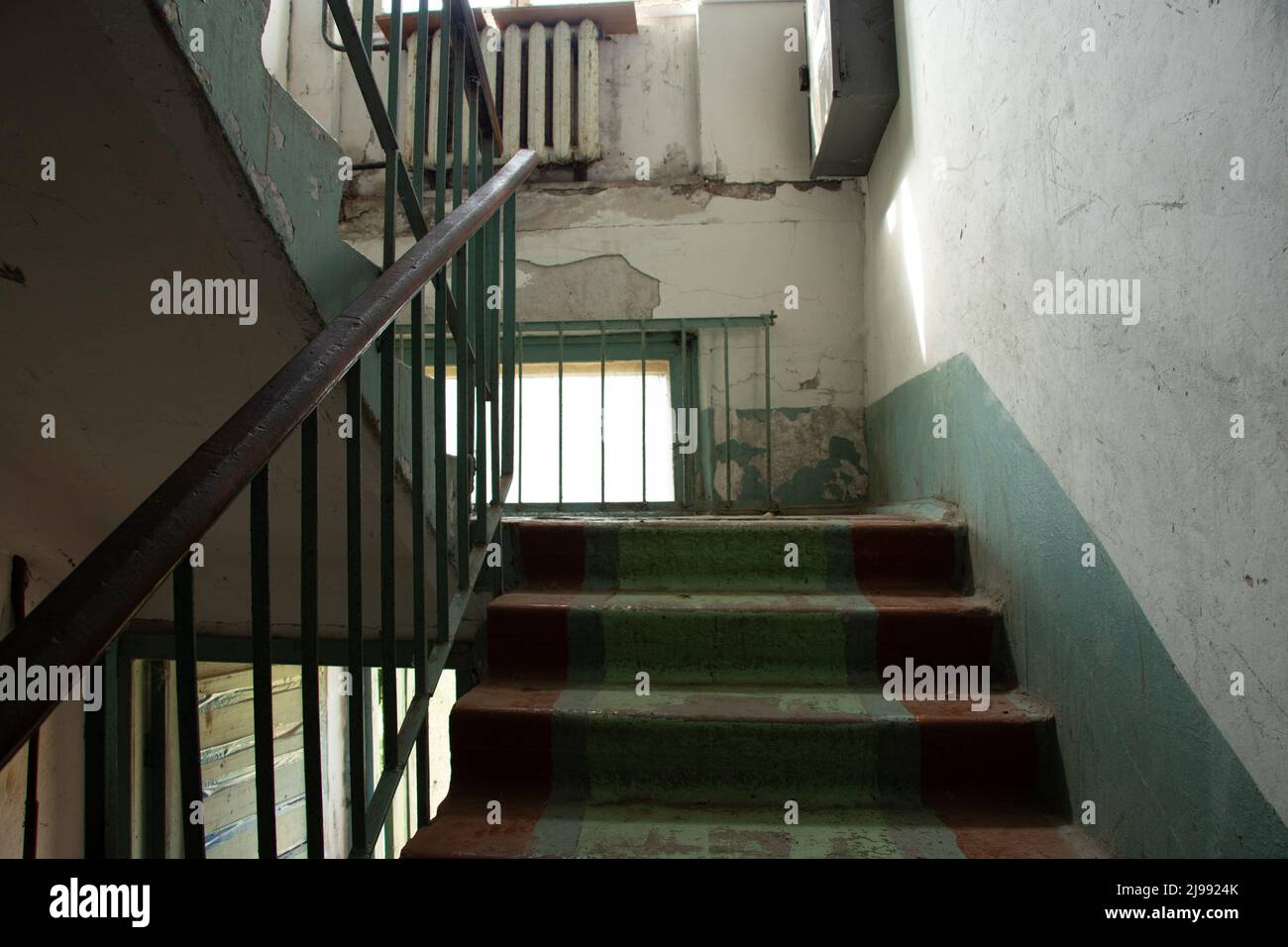 old dirty staircase without repair with a staircase in a residential ...