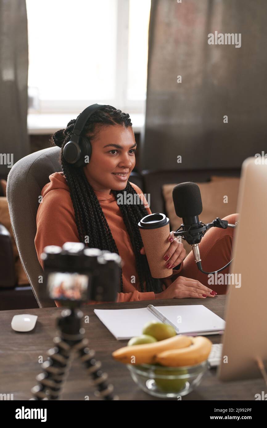 Vertical medium shot of fashionable young woman with afro braids ...