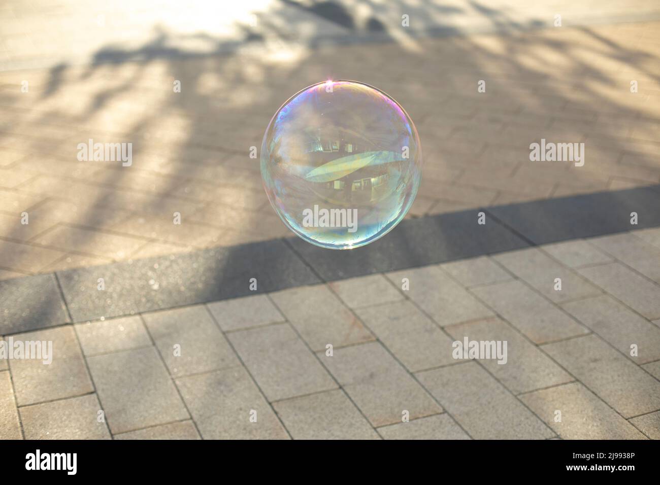 Bubble flies over road. Soap sphere. Details of fun Stock Photo - Alamy