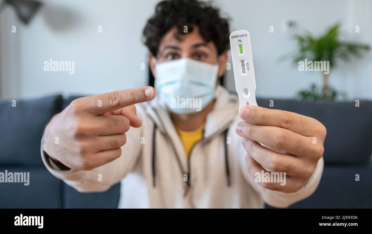 Happy caucasian man pointing hand to test showed a negative result for ...