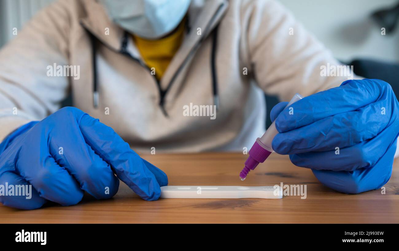 Close-up of man placing the sample into a buffer dropper for seft ...