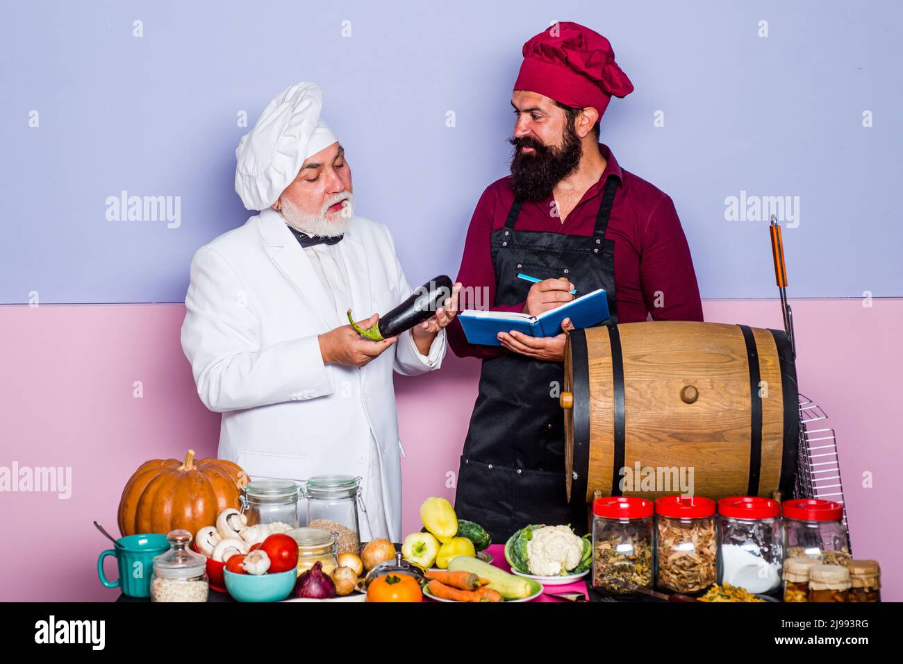Two smiling male chefs, cooks or bakers. Bearded chef standing in the ...