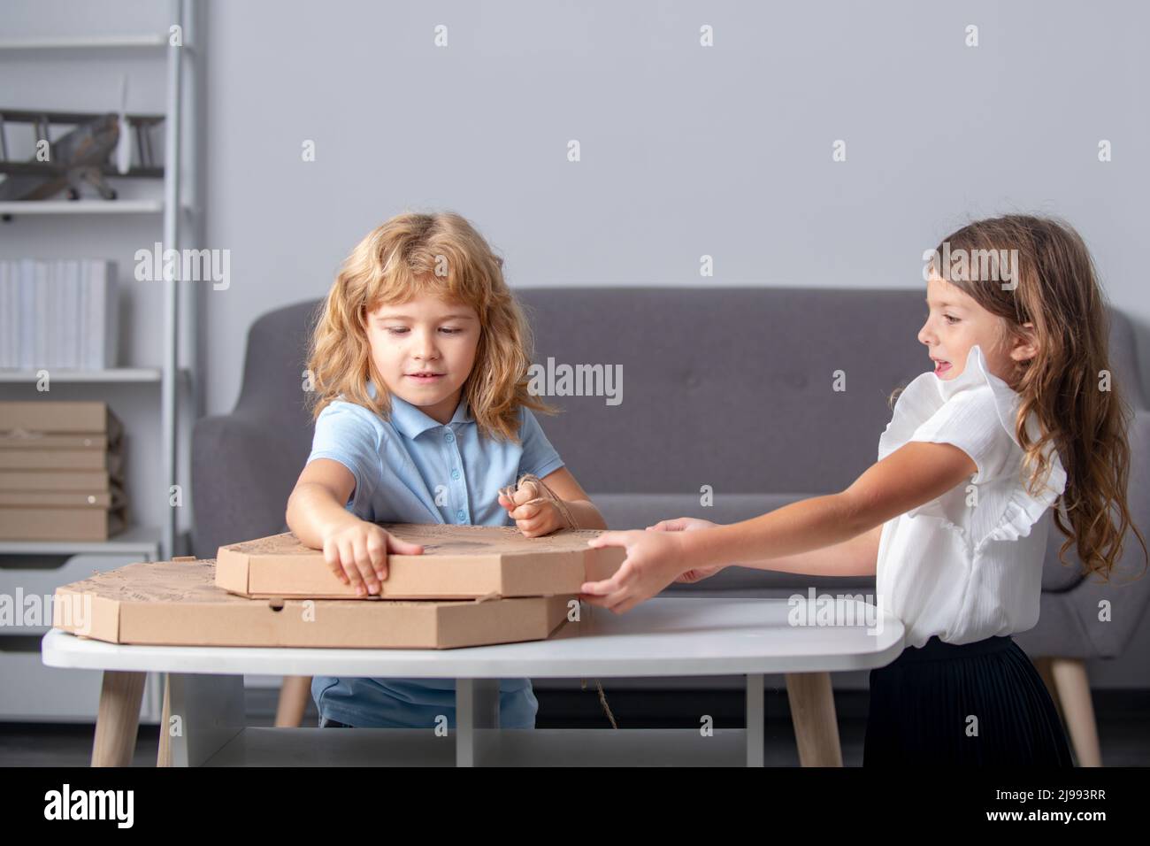 Kids open pizza box at home. Children preparing to eat pizza Stock ...