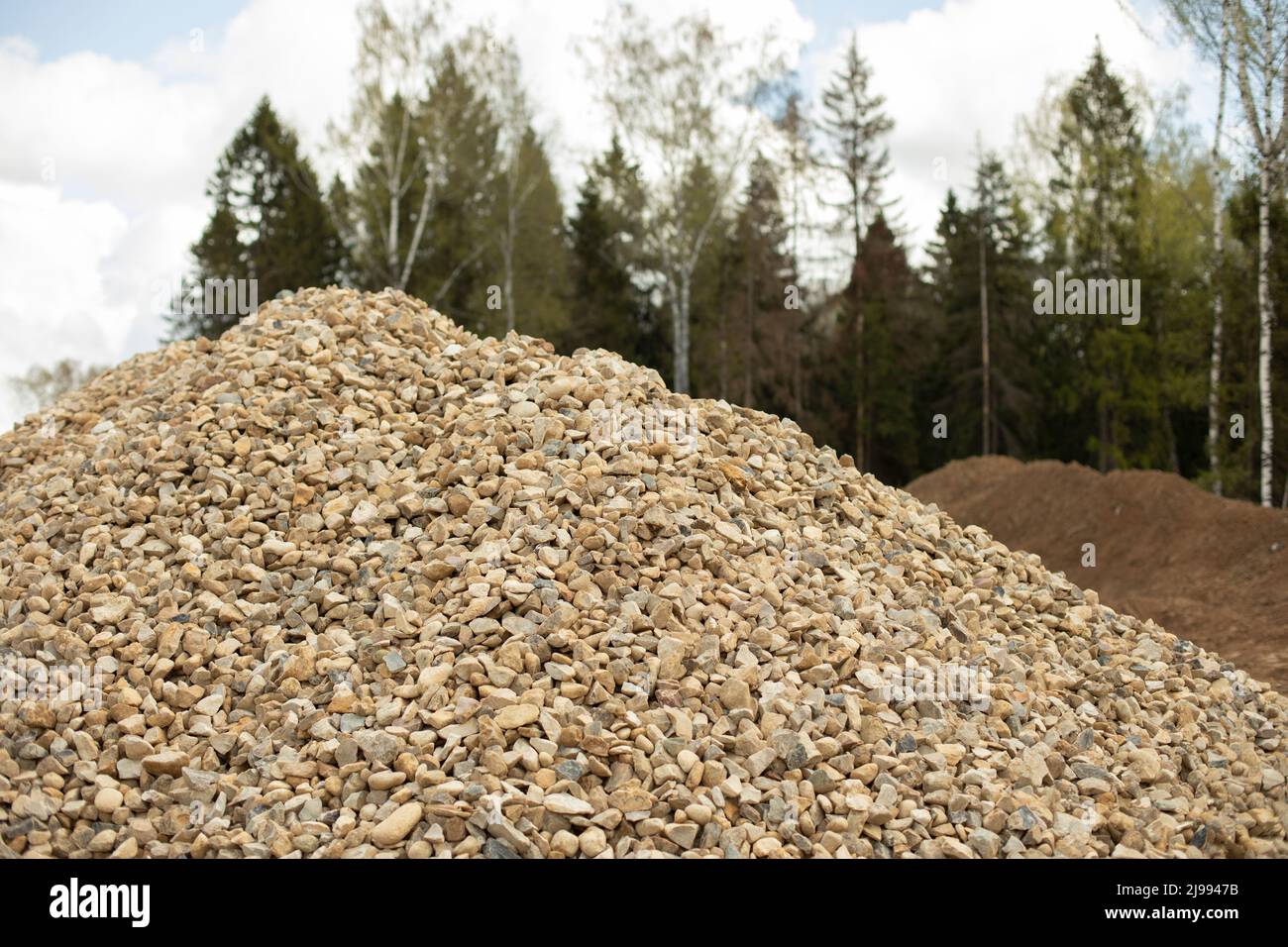Crushed stone at construction site. Mound of stones. Building material ...