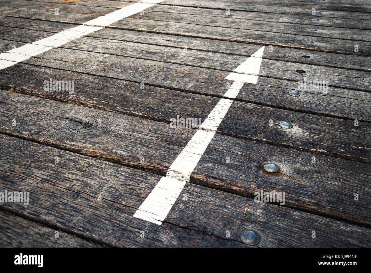 retro background or texture a white arrow on a wooden bridge Stock ...