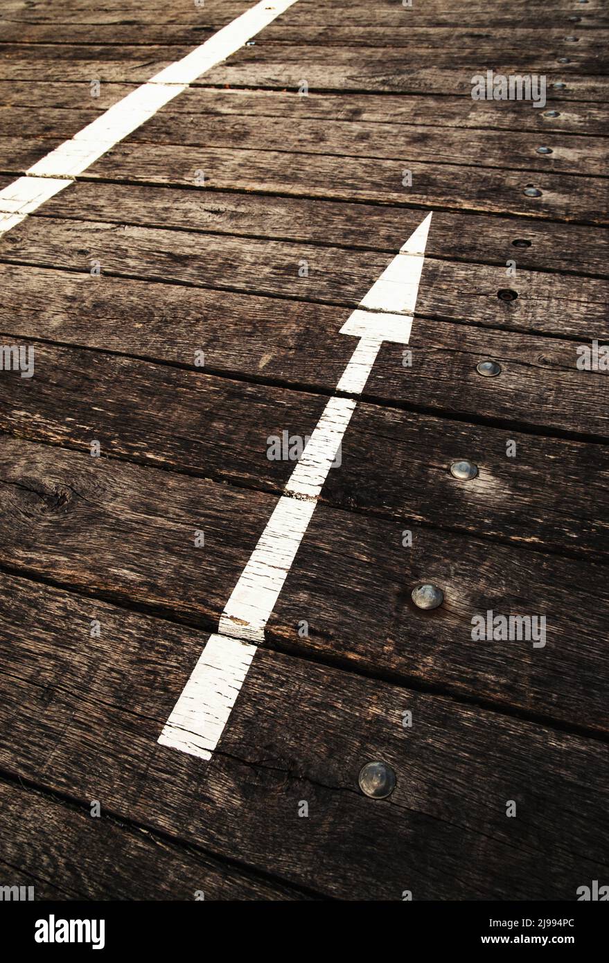 retro background or texture a white arrow on a wooden bridge Stock ...