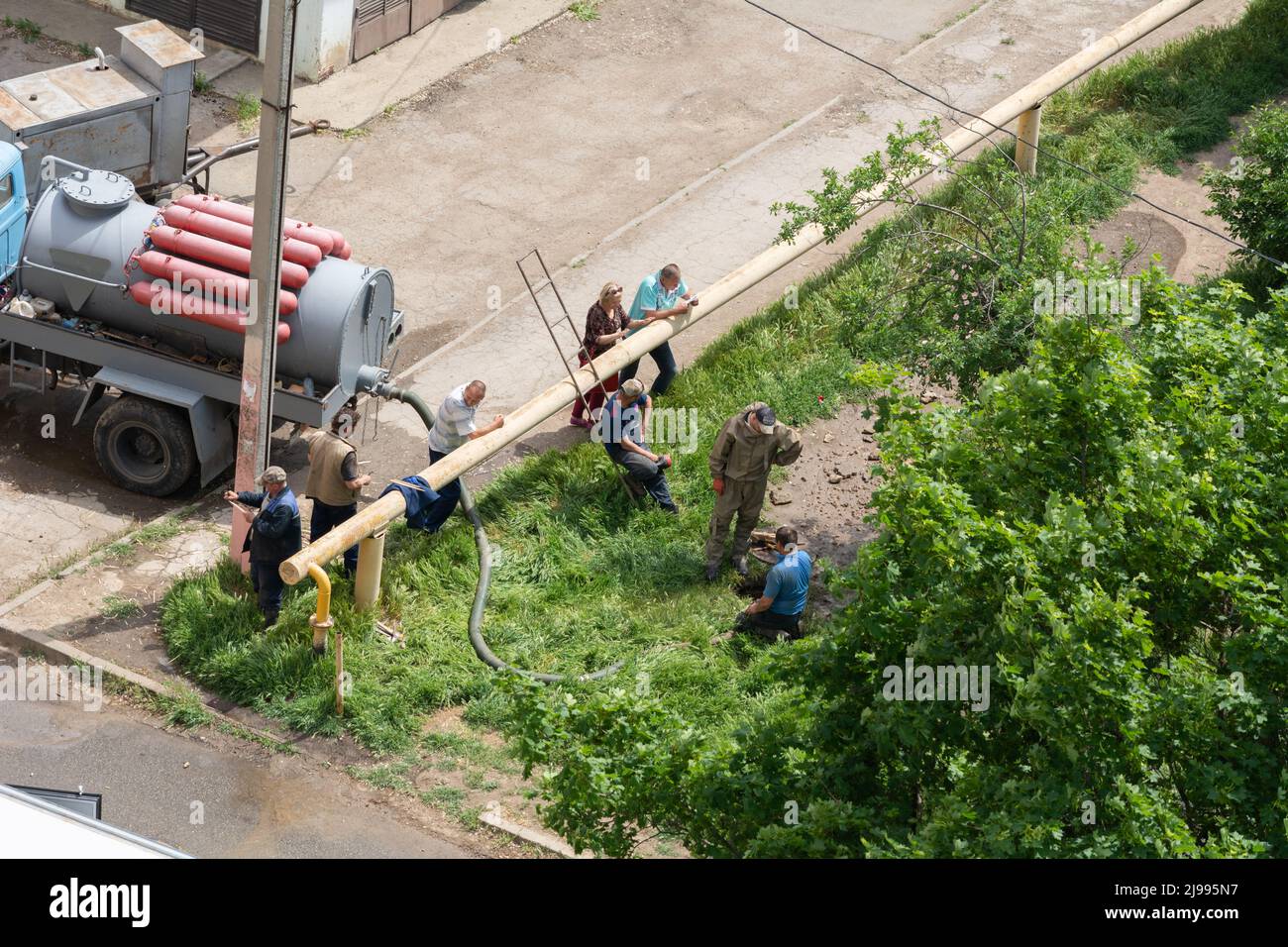 Tiraspol, Moldova - May 17, 2022: Male workers fixes a break in a water ...