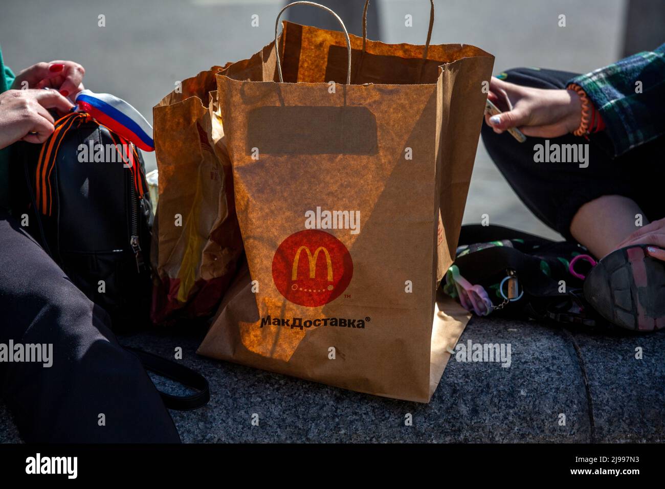 Moscow, Russia. 21st May, 2022. Customers eat outside a McDonald's fast ...