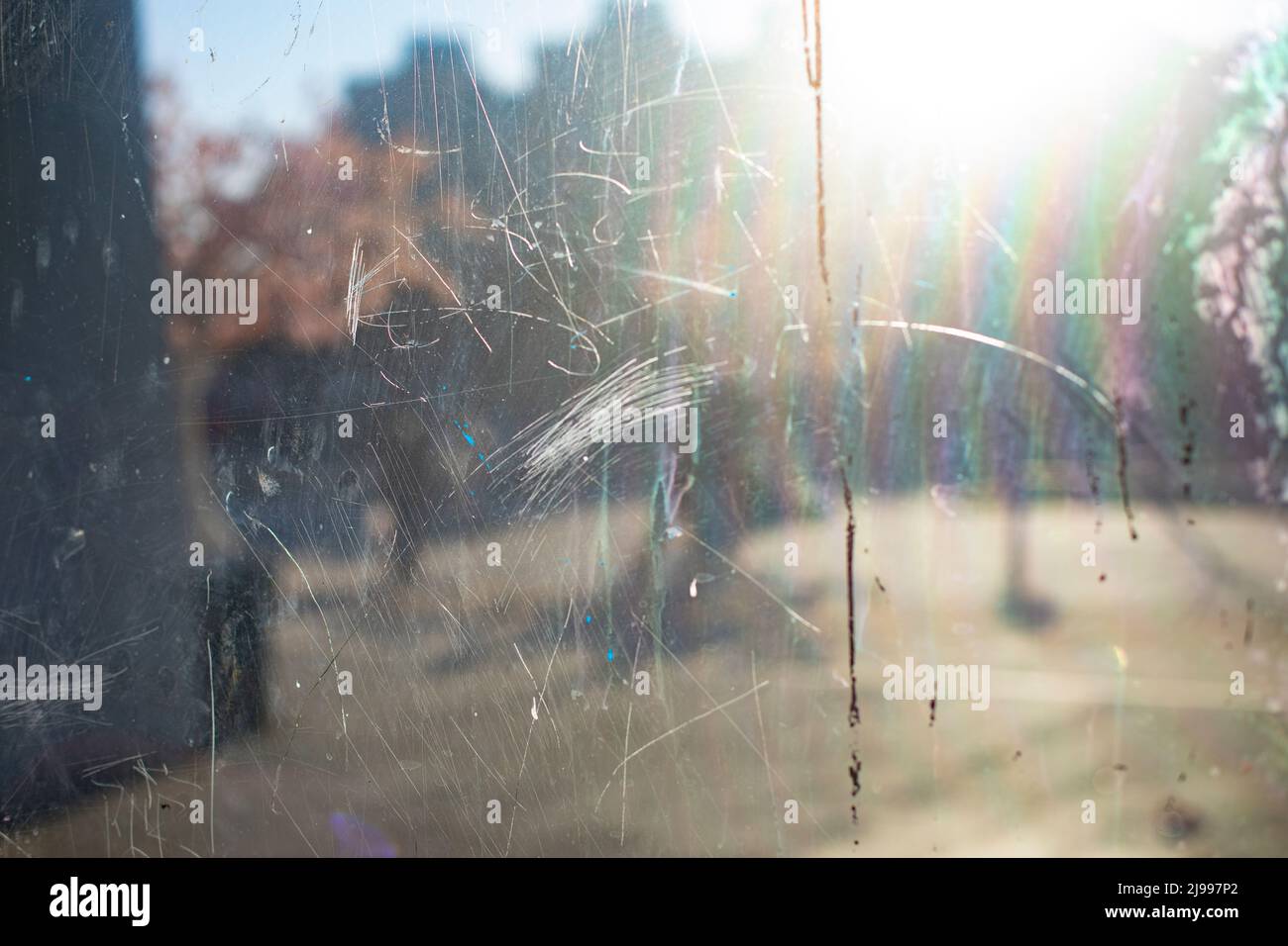 Scratched mirror. Damaged surface of glass. Dirt in display case ...