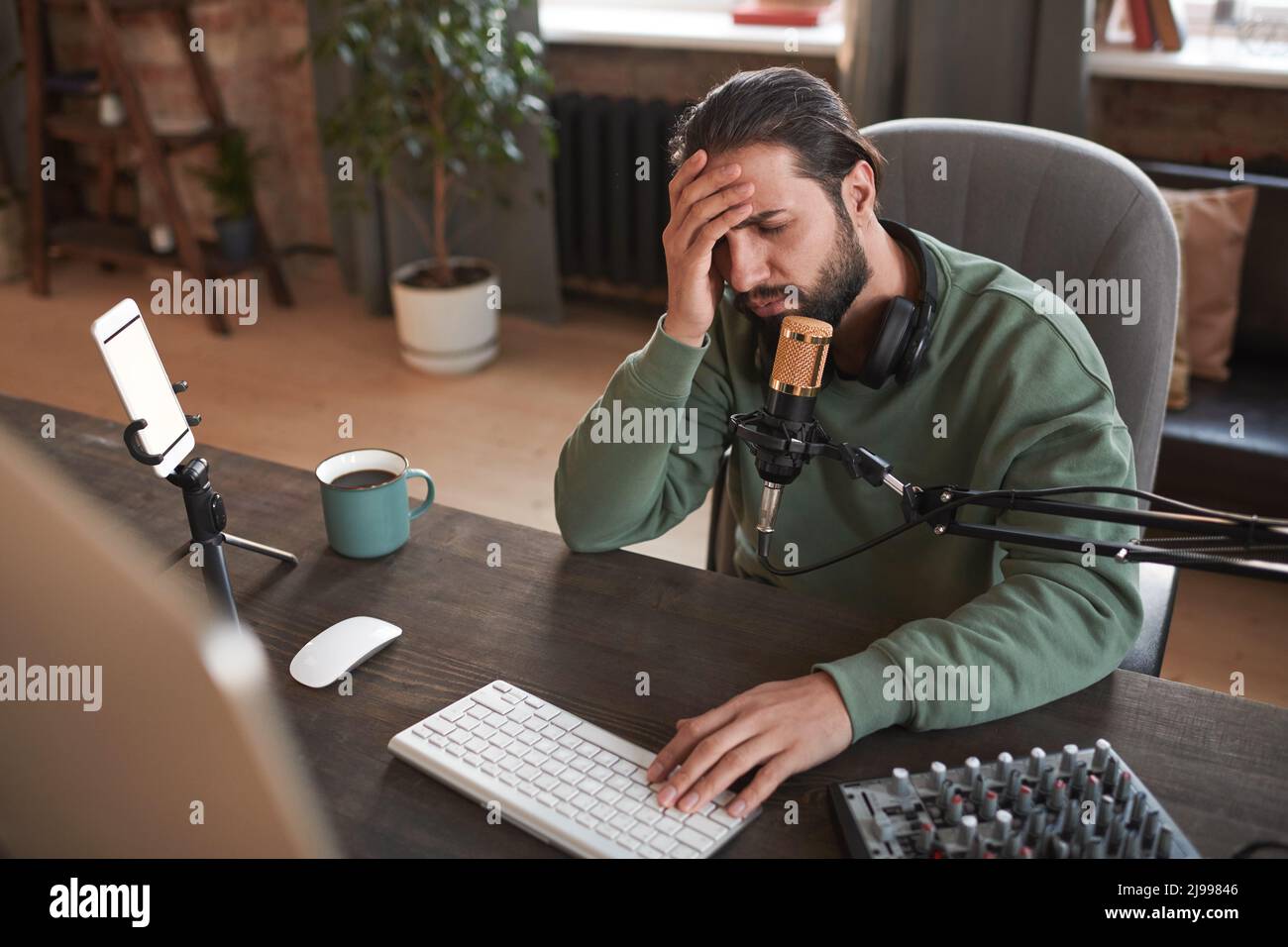 Horizontal medium portrait of tired young Middle Eastern man wearing ...