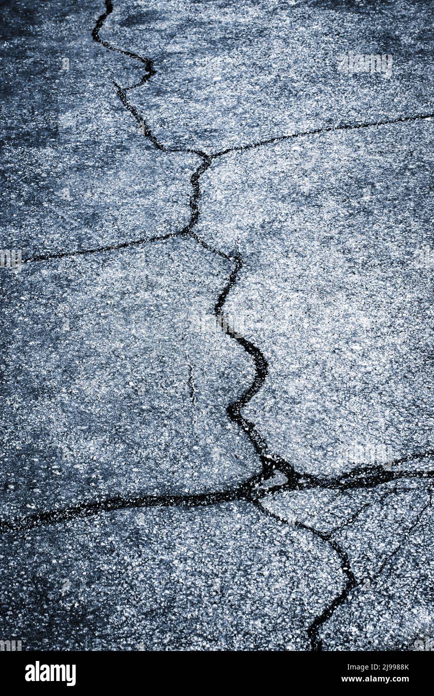 abstract background or texture wide cracks on a dark asphalt Stock ...