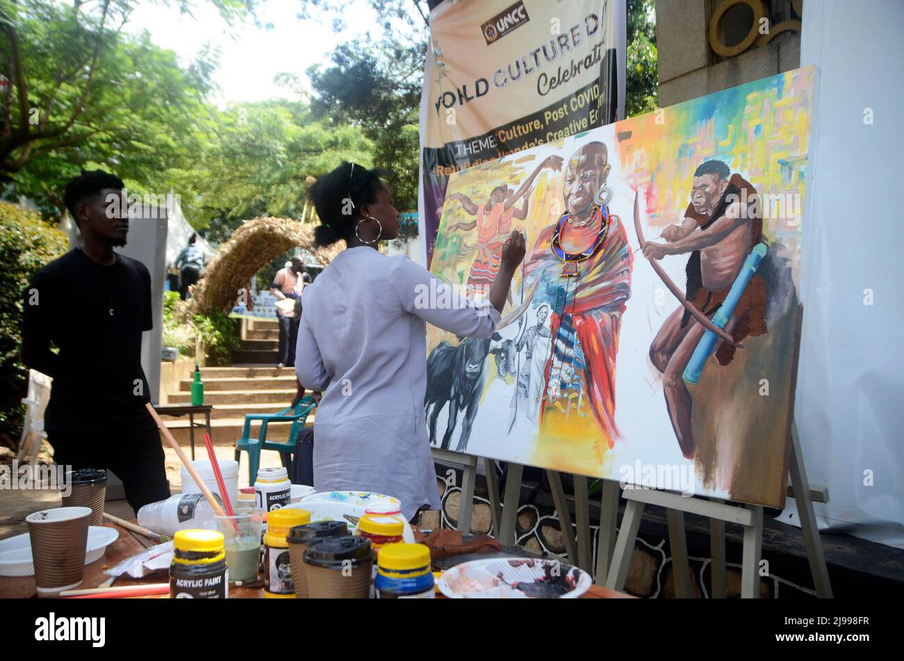 Kampala, Uganda. 21st May, 2022. An artist works on a painting during ...