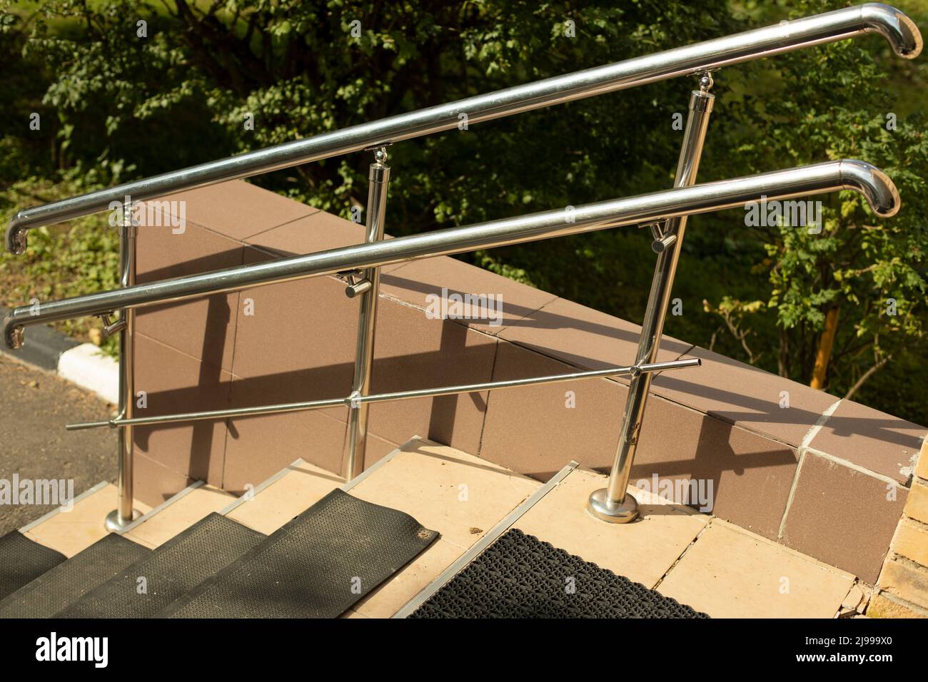 Handrail of stairs. Hand railing. Stairs are short. Details of entrance ...
