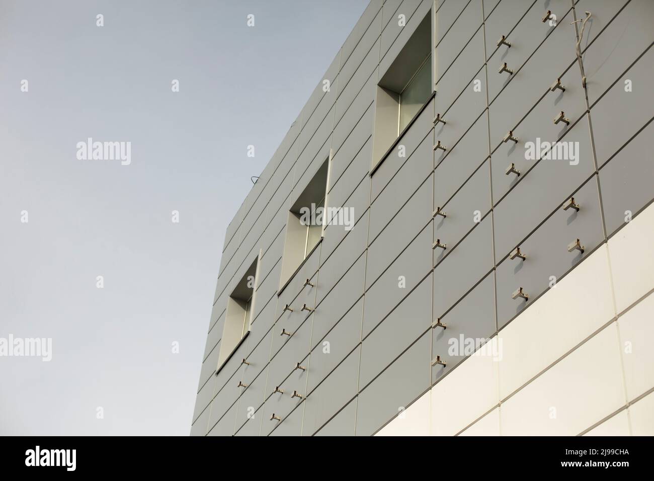 Modern building is gray in color. Facing panel on office building ...