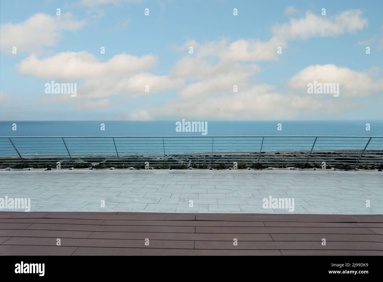 Wooden platform with a chrome railing overlooking the sea Stock Photo ...