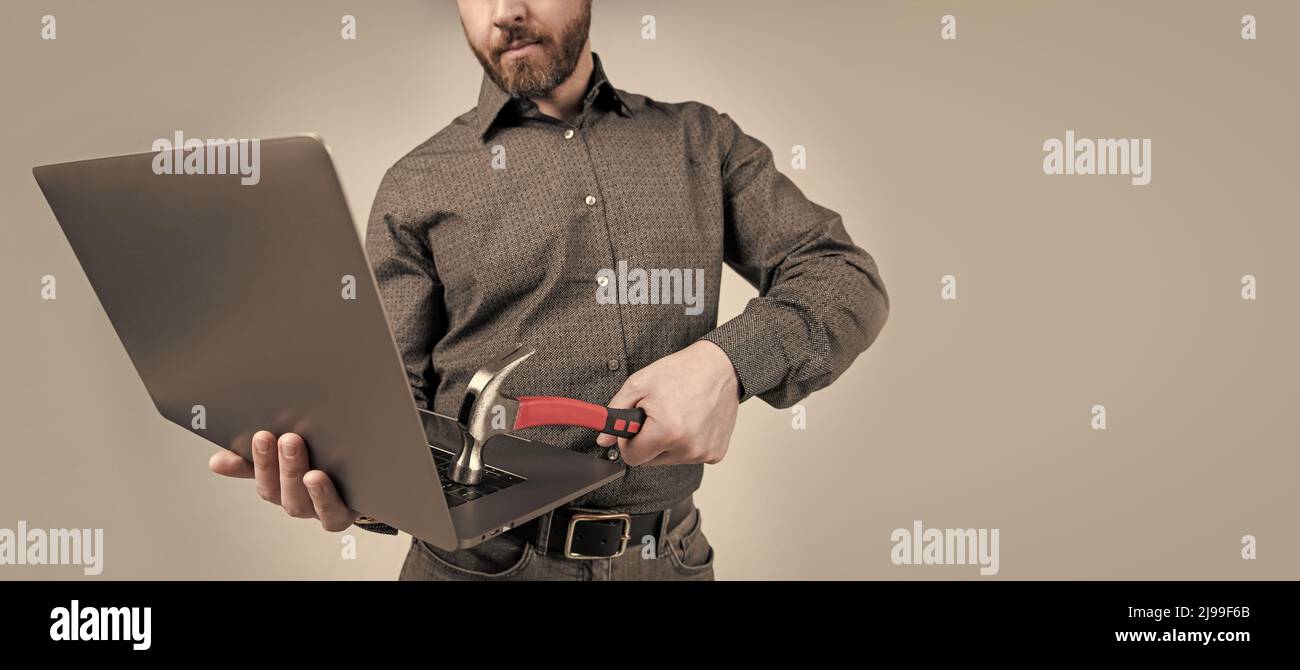Unshaven man cropped view break laptop hitting computer with hammer ...