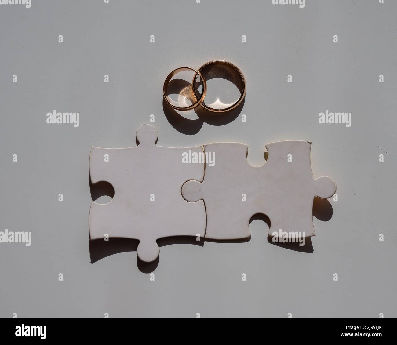 Wedding rings and puzzle pieces. Husband and wife complement each other ...