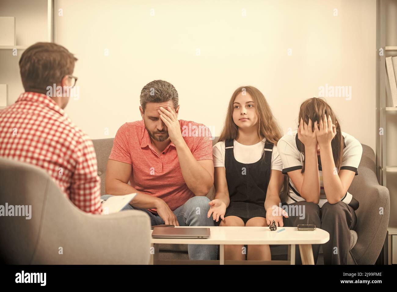 family therapy. parents with kid talk to social worker. mom dad and ...