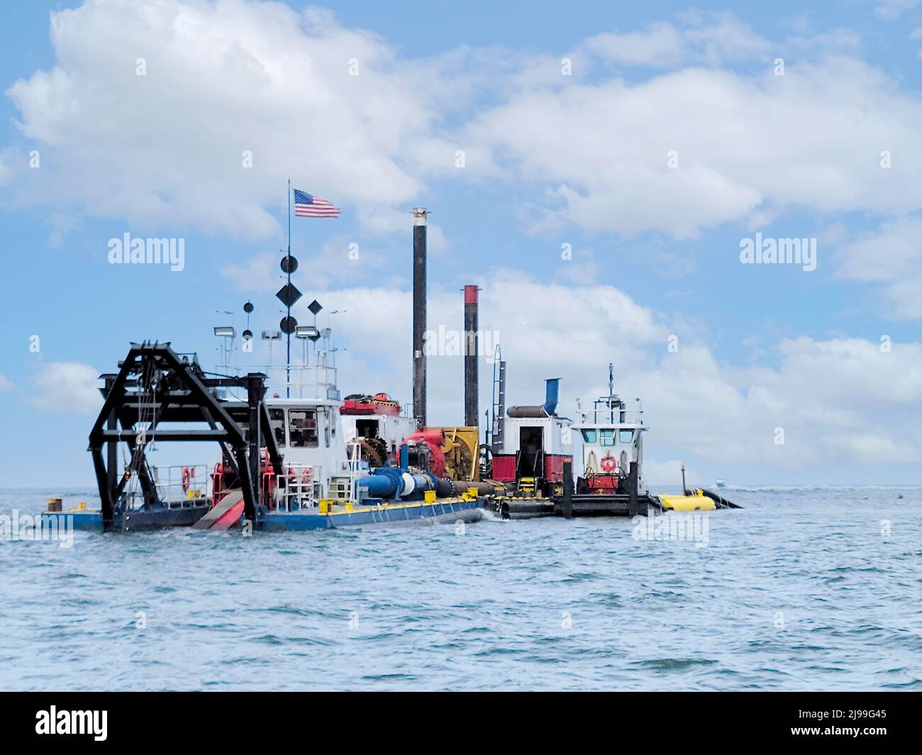 Barge dredging the harbor on Lake Michigan with sky background Stock ...