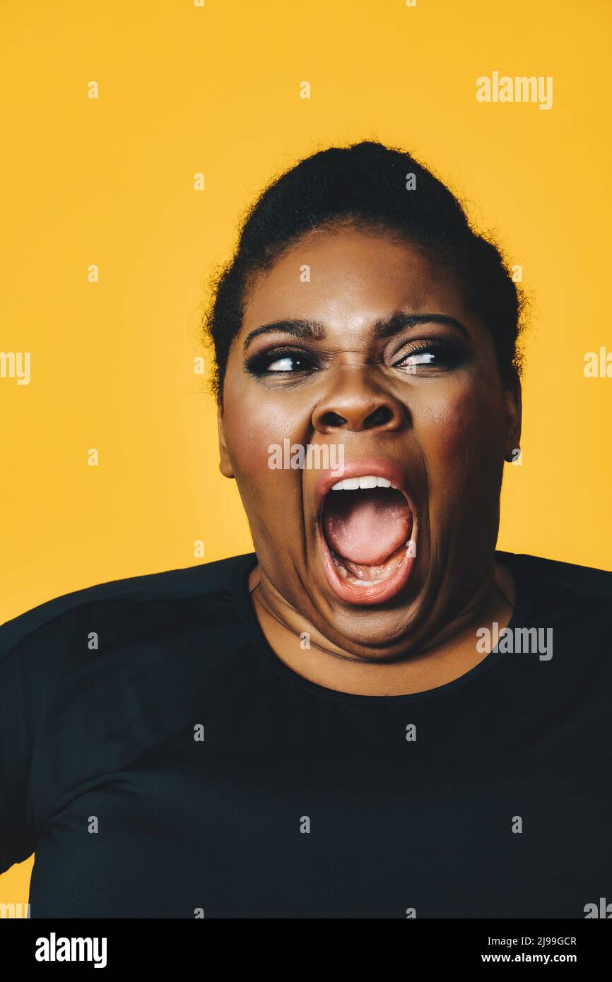 closeup portrait of a young adult african american woman in shock with ...