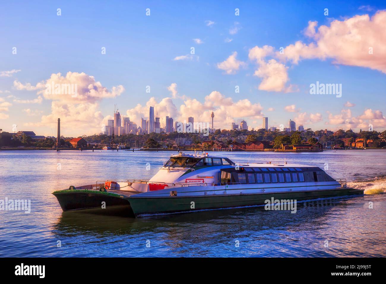 Passenger rivercat ferry on Parramatta river in view of Sydney city CBD ...