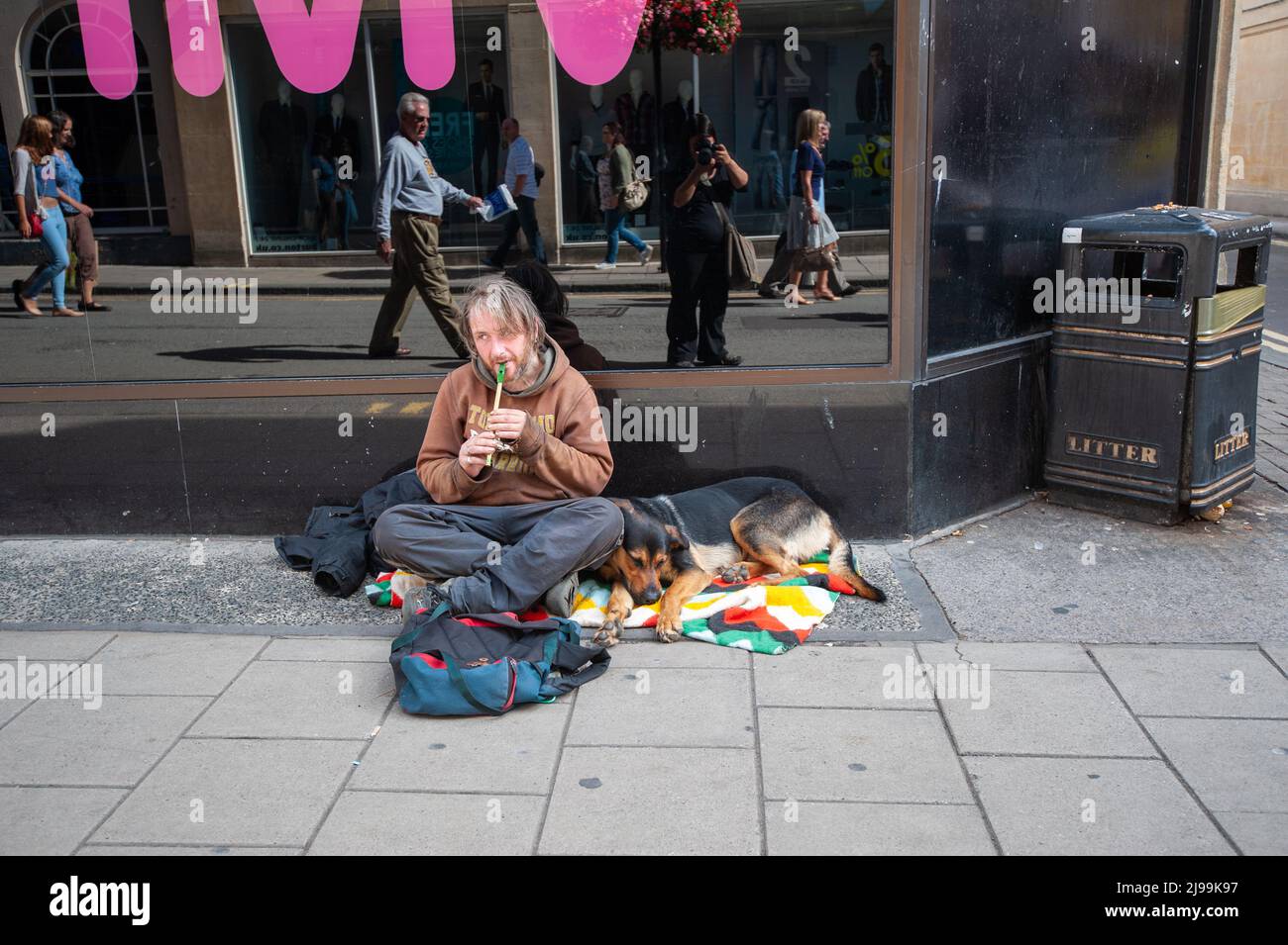 Homeless Busker playing on the street in Bath Stock Photo - Alamy