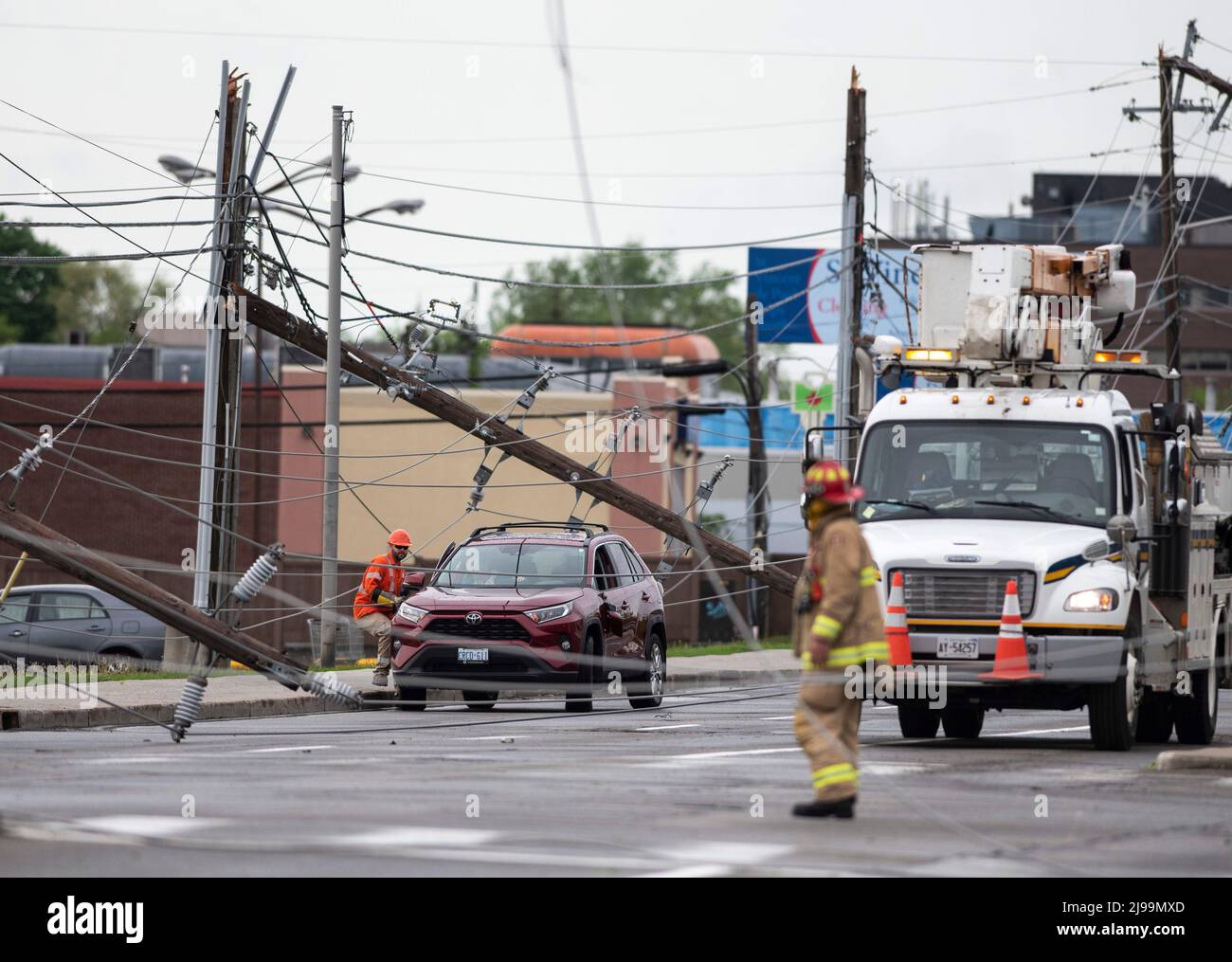 Ottawa, Can. 21st May, 2022. A utility worker speaks to a motorist ...