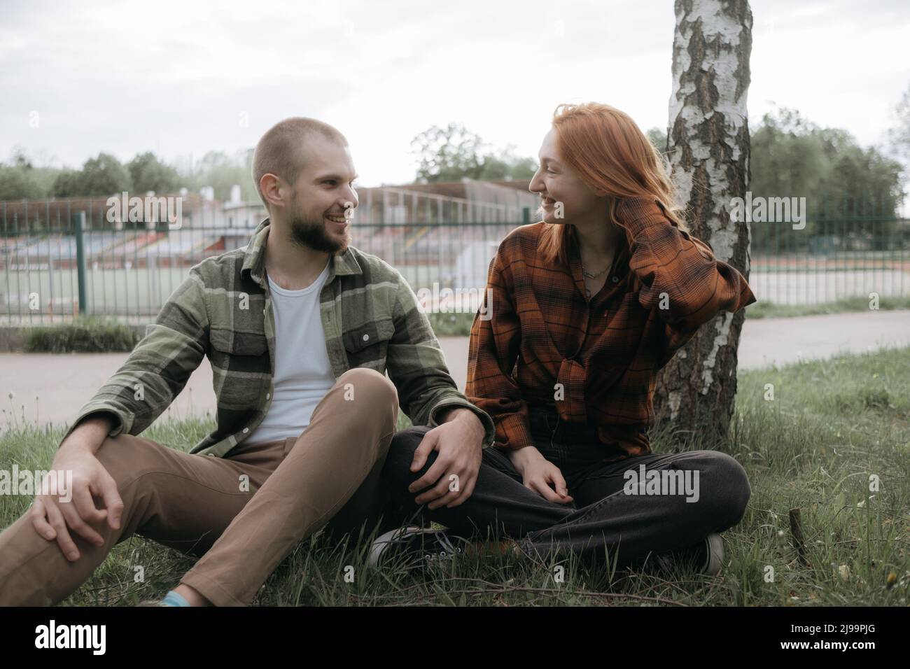lovers sit in the park on the grass Stock Photo - Alamy
