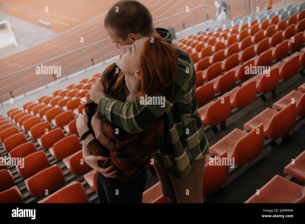 loved ones hug standing in the stadium stand Stock Photo - Alamy