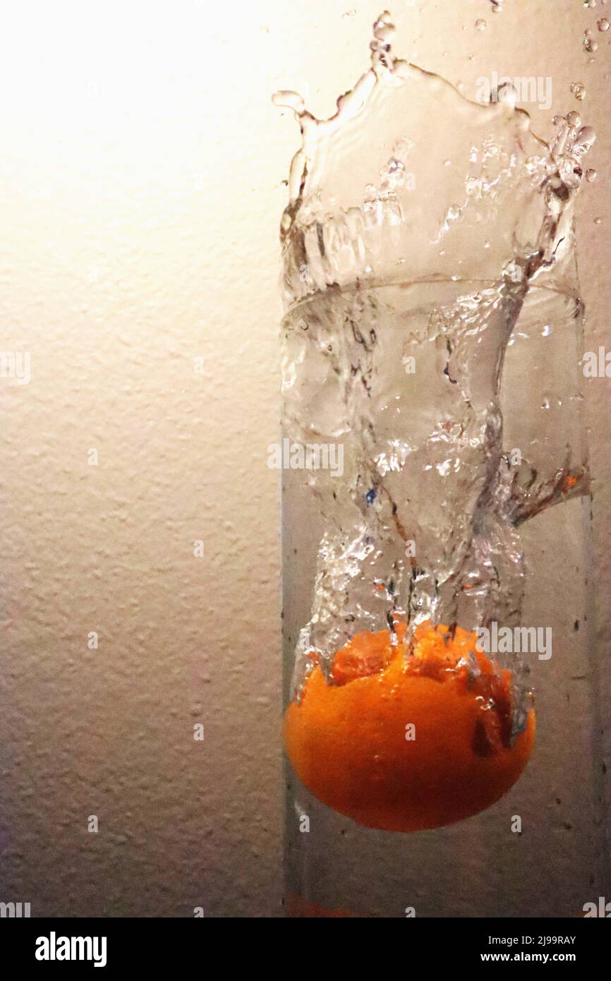 Orange Splashing Glass Vase Stock Photo - Alamy