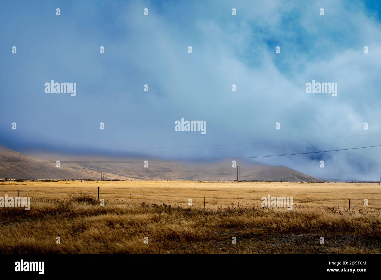 Low cloud hangs over rural and alpine Burkes Pass landscape of ...