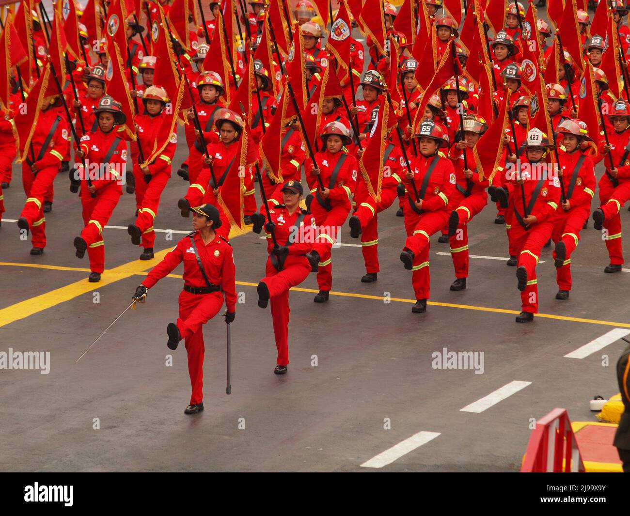 Battalion of female volunteer firefighters marching in the parade for ...