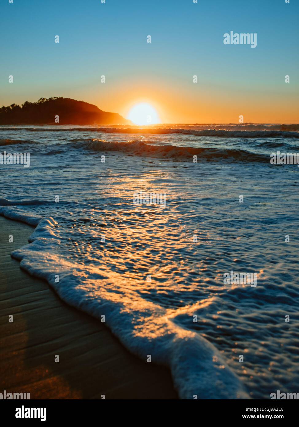 Colorful ocean beach sunrise with deep blue sky and sun rays Stock ...