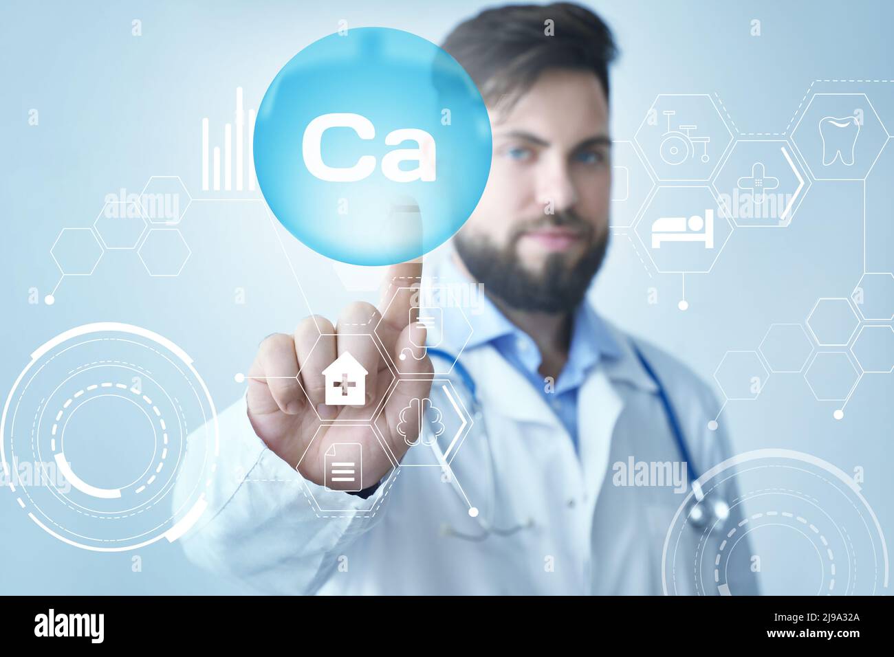 Male doctor using virtual screen with chemical element Calcium on light ...
