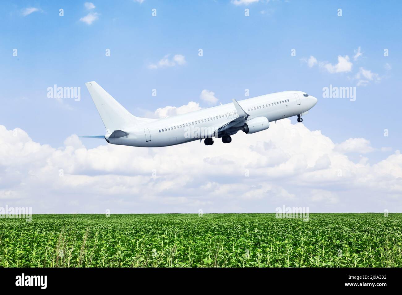 View of flying airplane in blue sky Stock Photo - Alamy