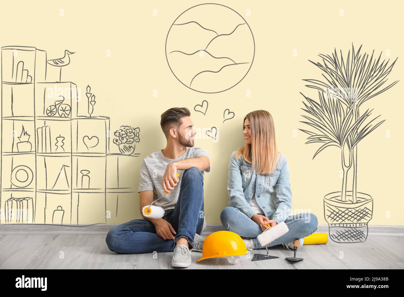 Happy couple planning design of their new house Stock Photo - Alamy