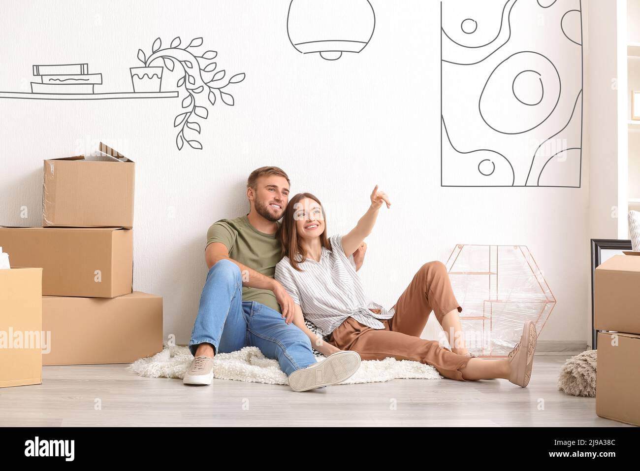 Happy couple planning design of their new home Stock Photo - Alamy